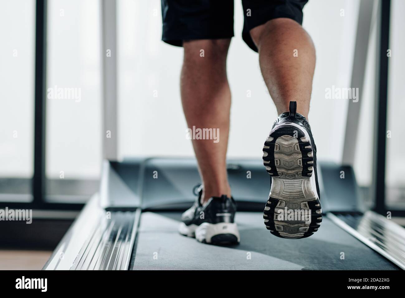 Fit man running on treadmill Stock Photo - Alamy