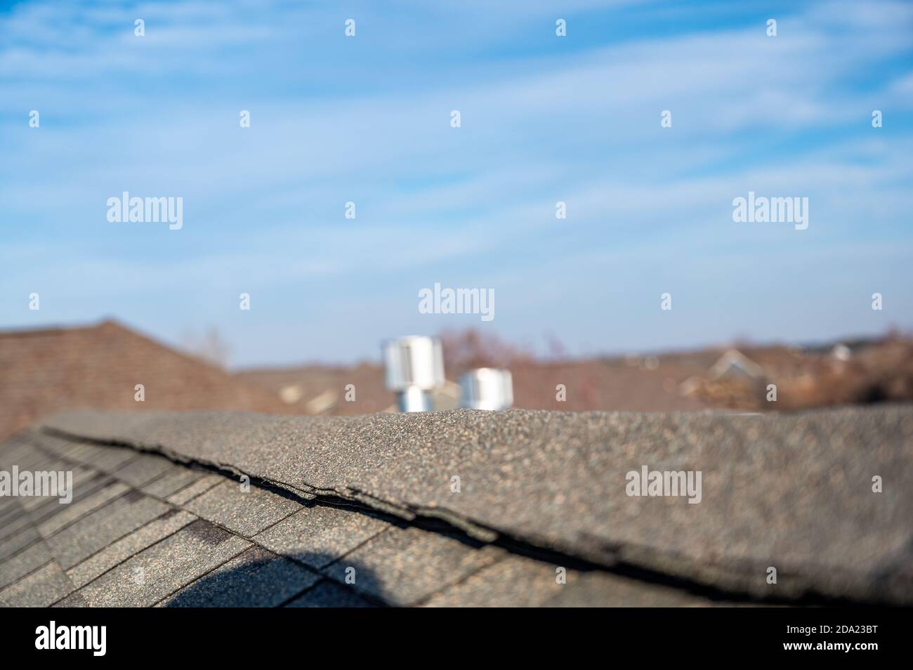 Typical residentail ridge cap on a shingle roof apex Stock Photo - Alamy