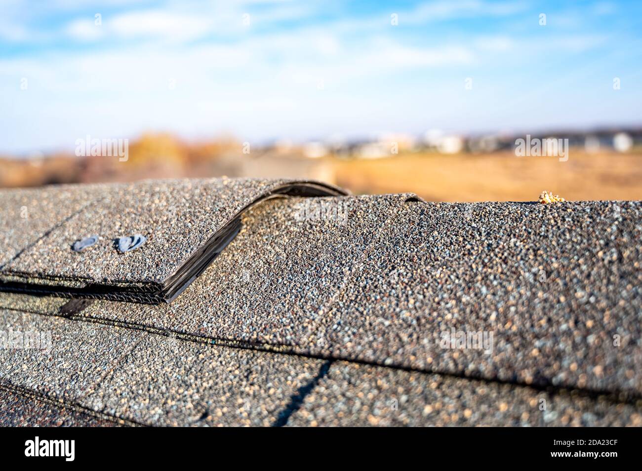 Typical residentail ridge cap on a shingle roof apex Stock Photo - Alamy