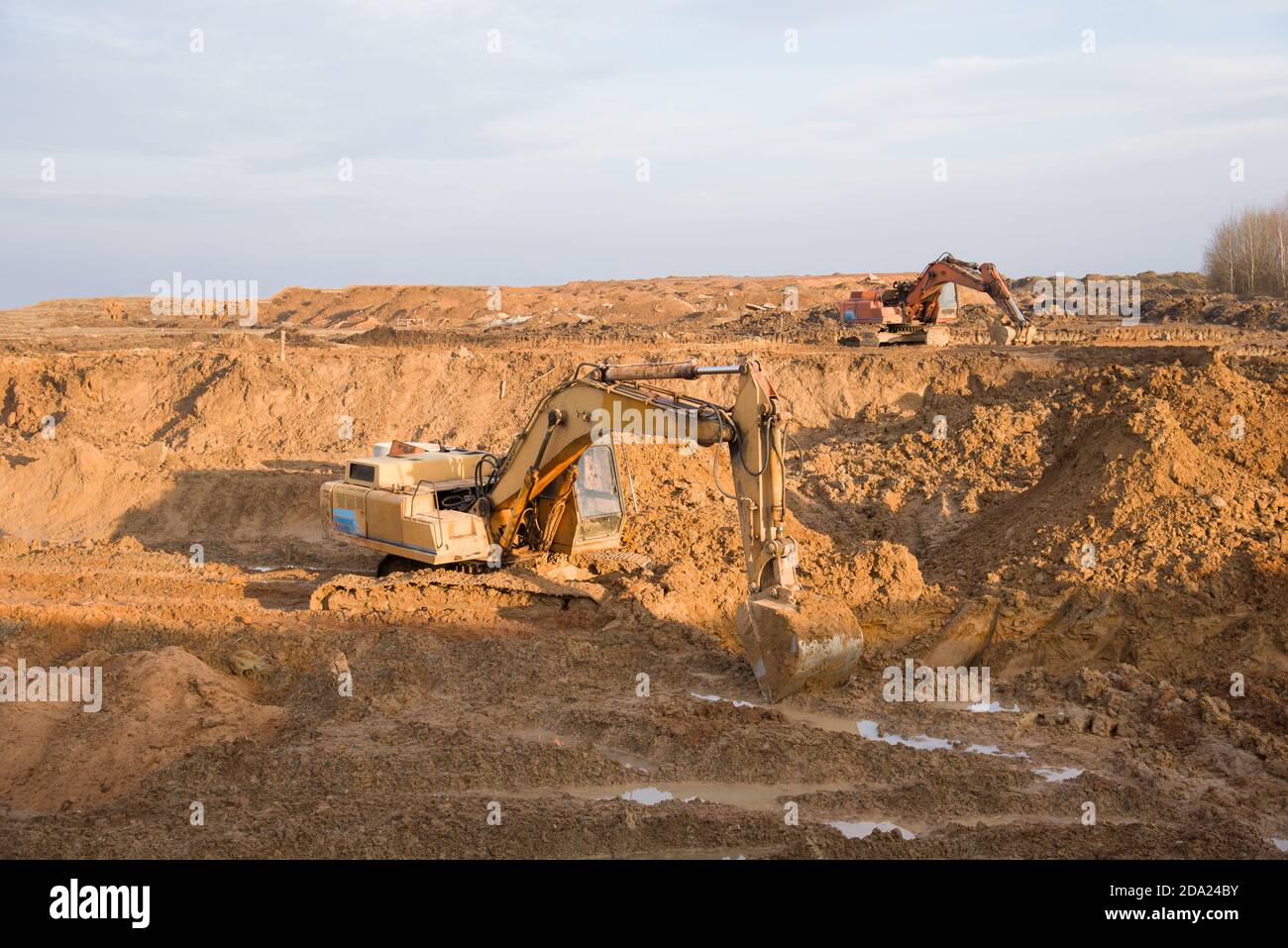 Excavators working at open-pit mining. Backhoe during earthworks on ...