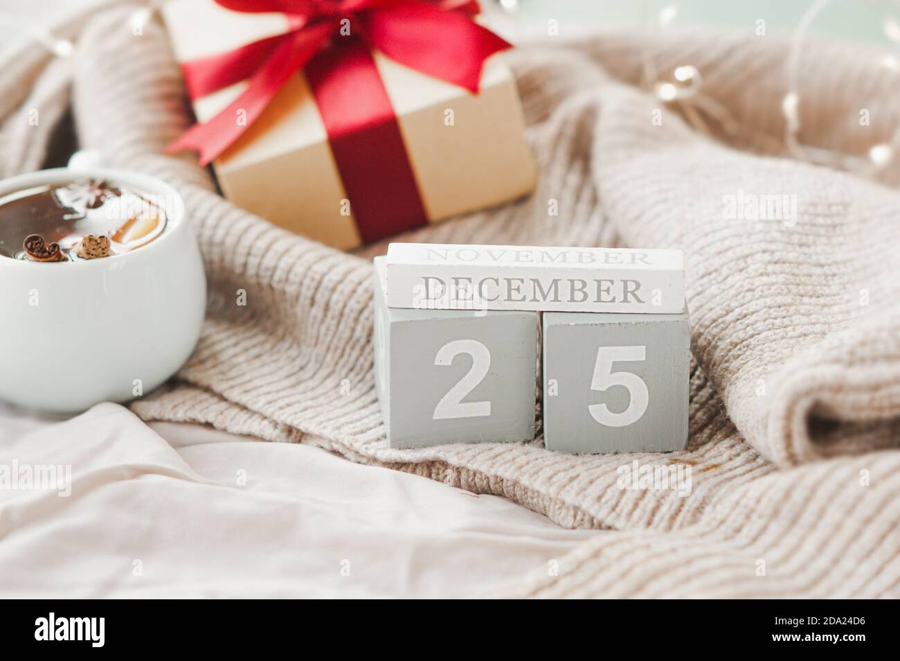 wooden square calendar cubes with the date December 25 on beige cozy ...