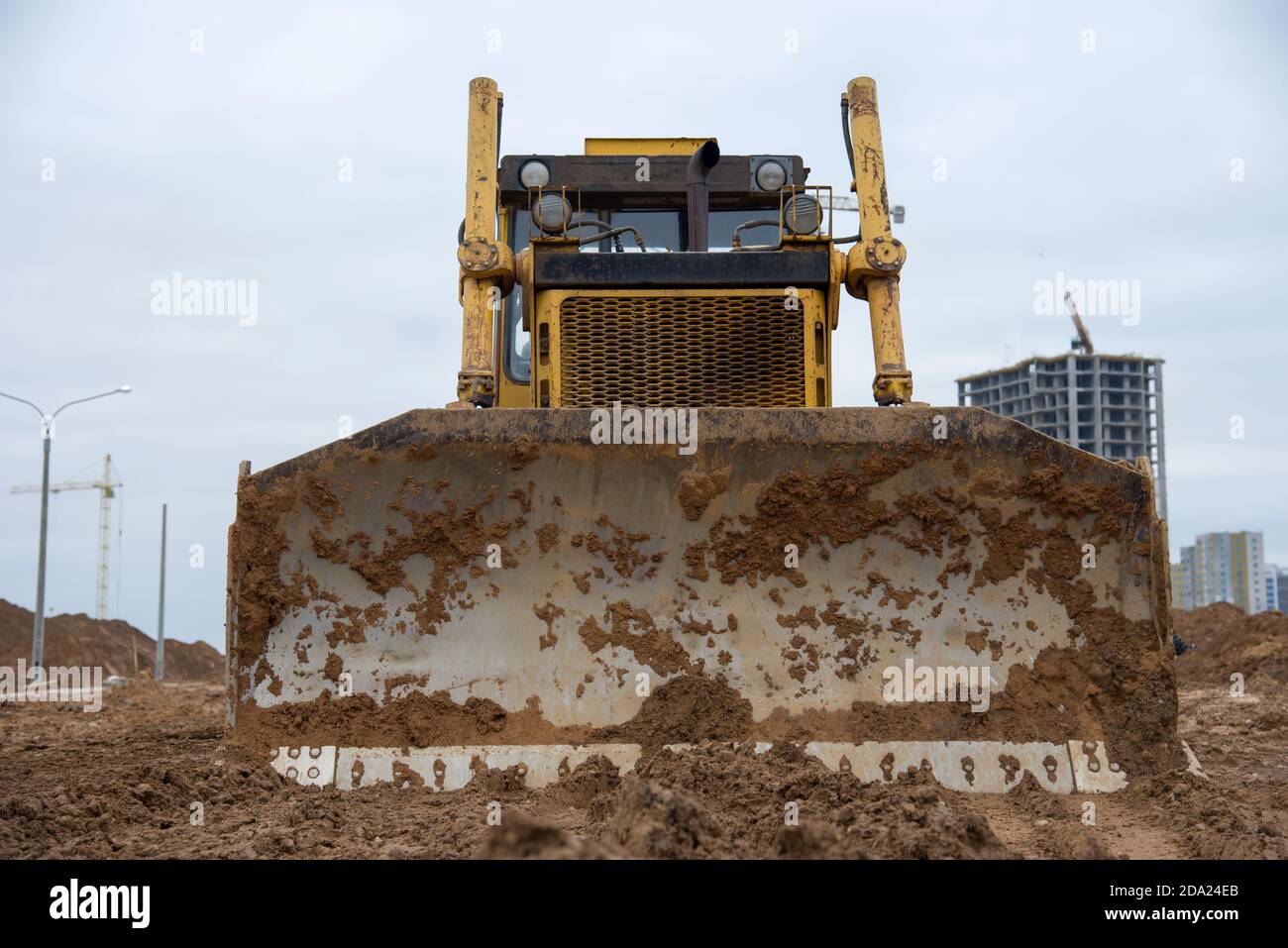 Bulldozer during land clearing and foundation digging at large ...