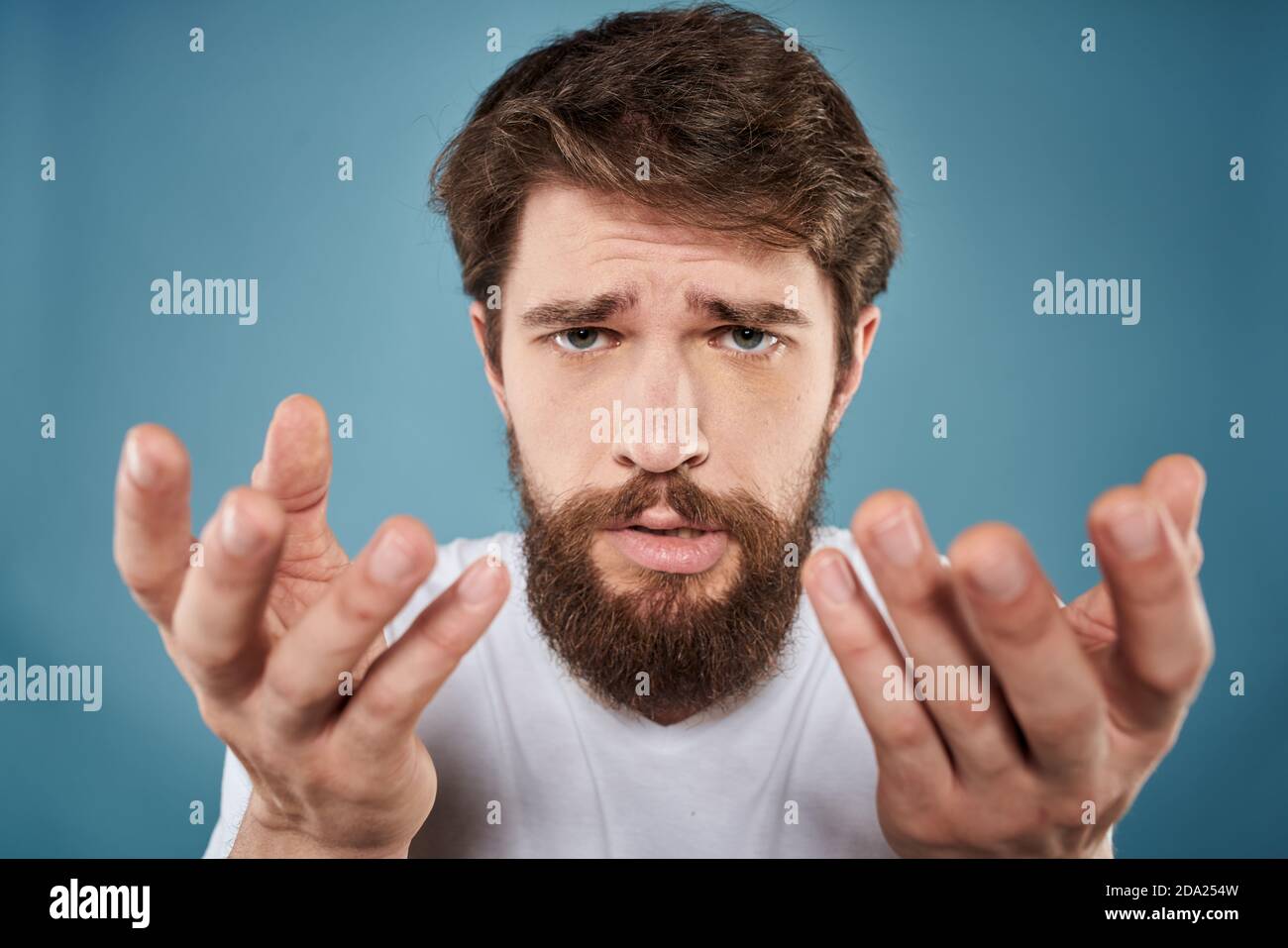 Bearded man displeased facial expression emotions close-up blue ...