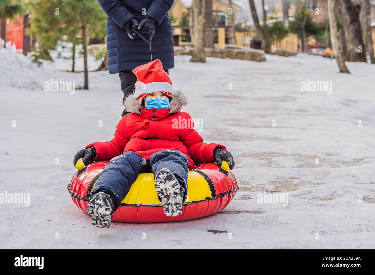 mom son wearing a medical mask during COVID-19 coronavirus ride on an ...