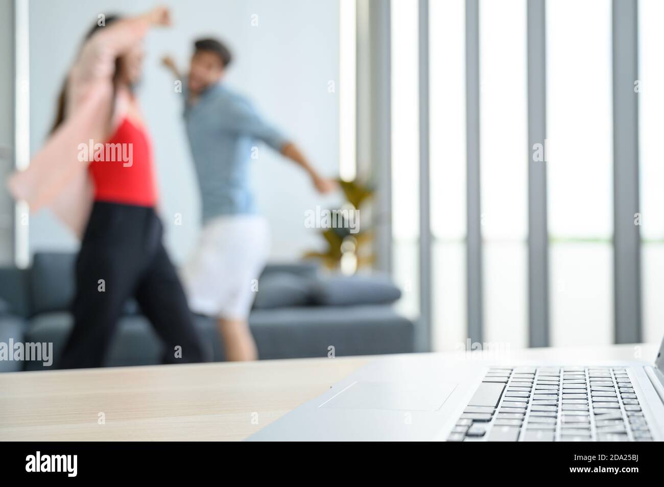 Laptop notebook computer on the table with happy and relax young couple ...