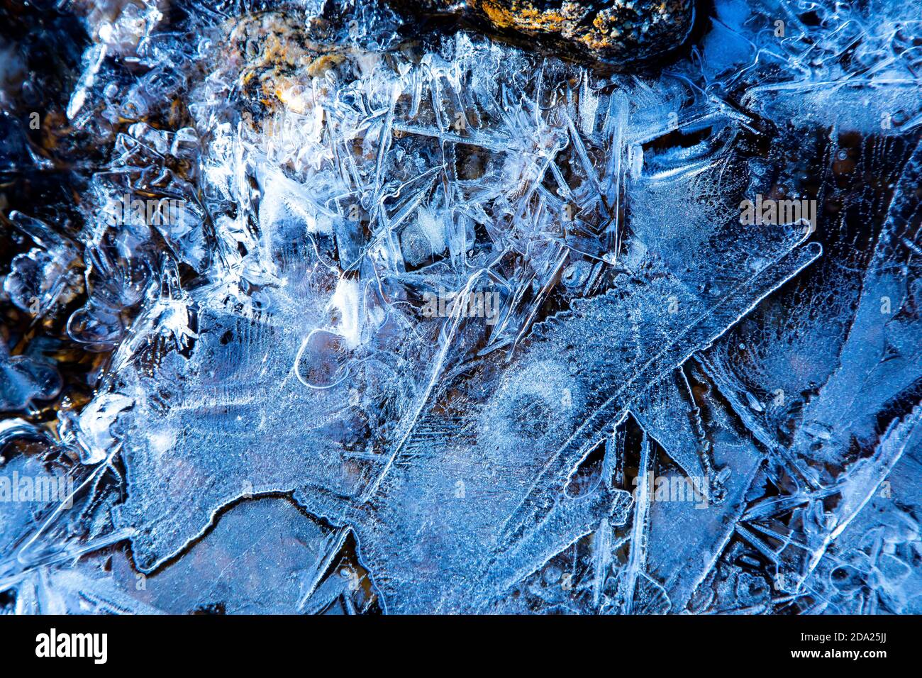 Patterns in ice of a frozen stream in the Swiss Alps Stock Photo - Alamy