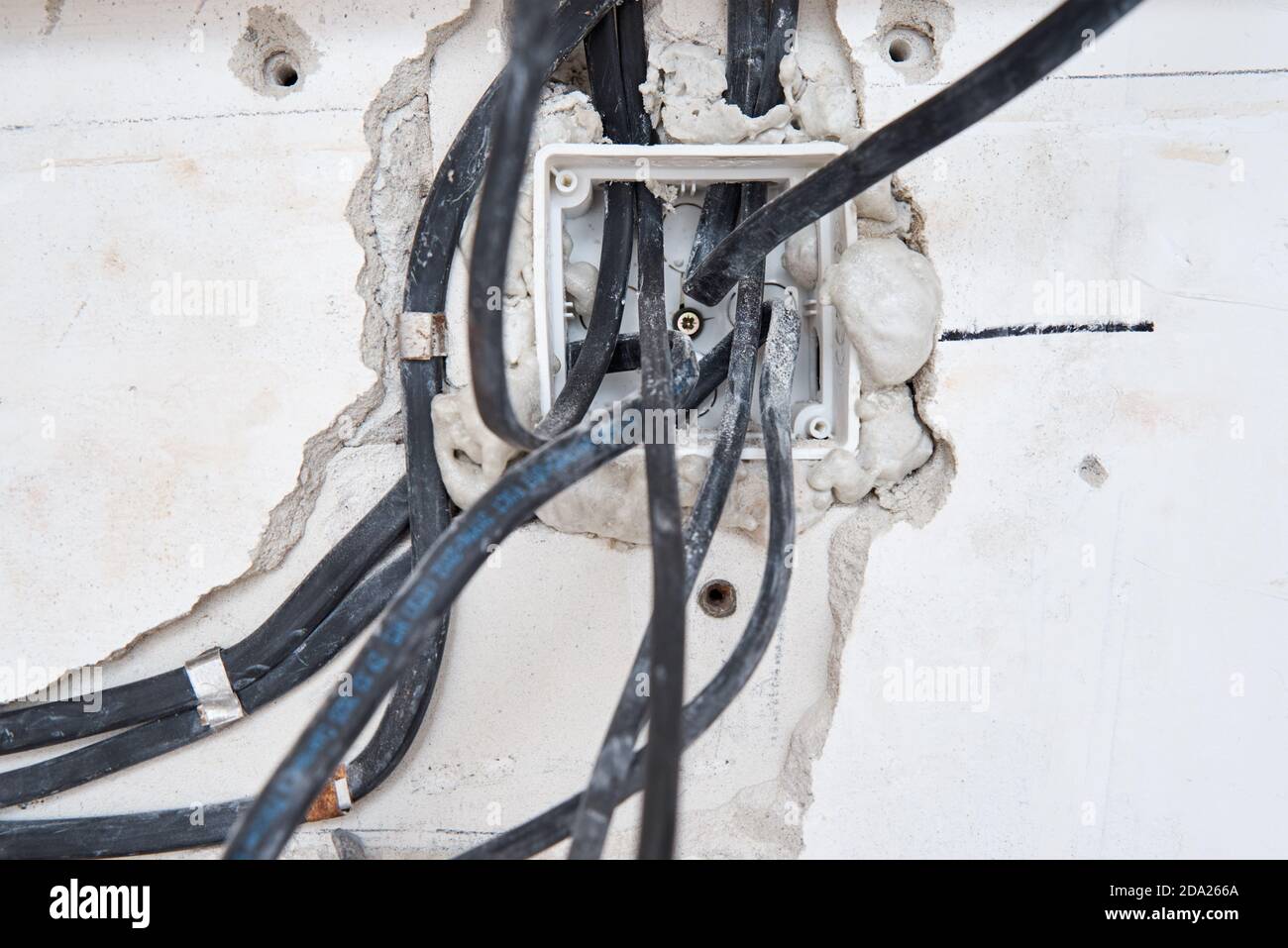 Socket for wiring in concrete wall. Renovation concept Stock Photo - Alamy