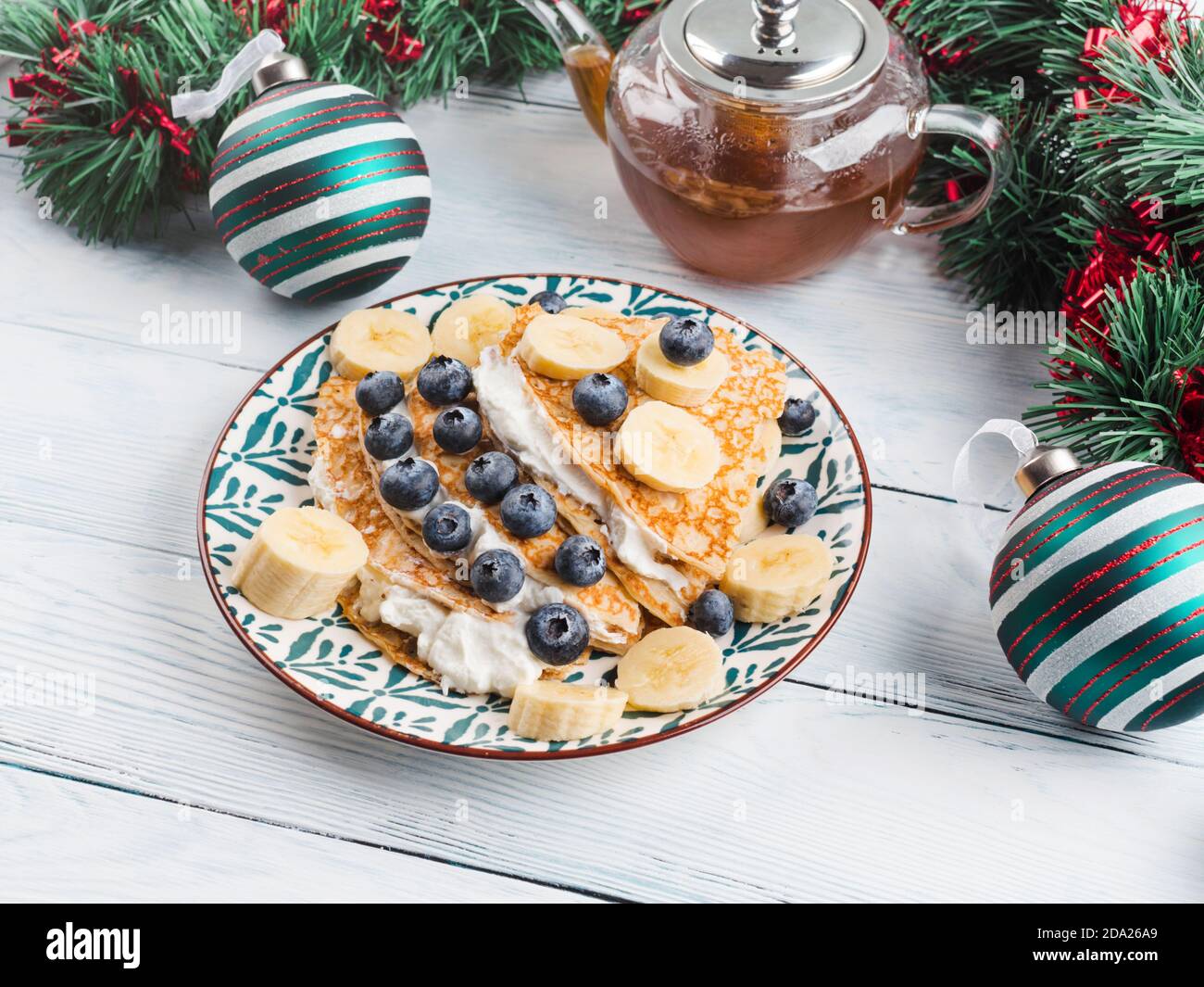 Christmas tree shaped crepes with quark, blueberry Stock Photo - Alamy