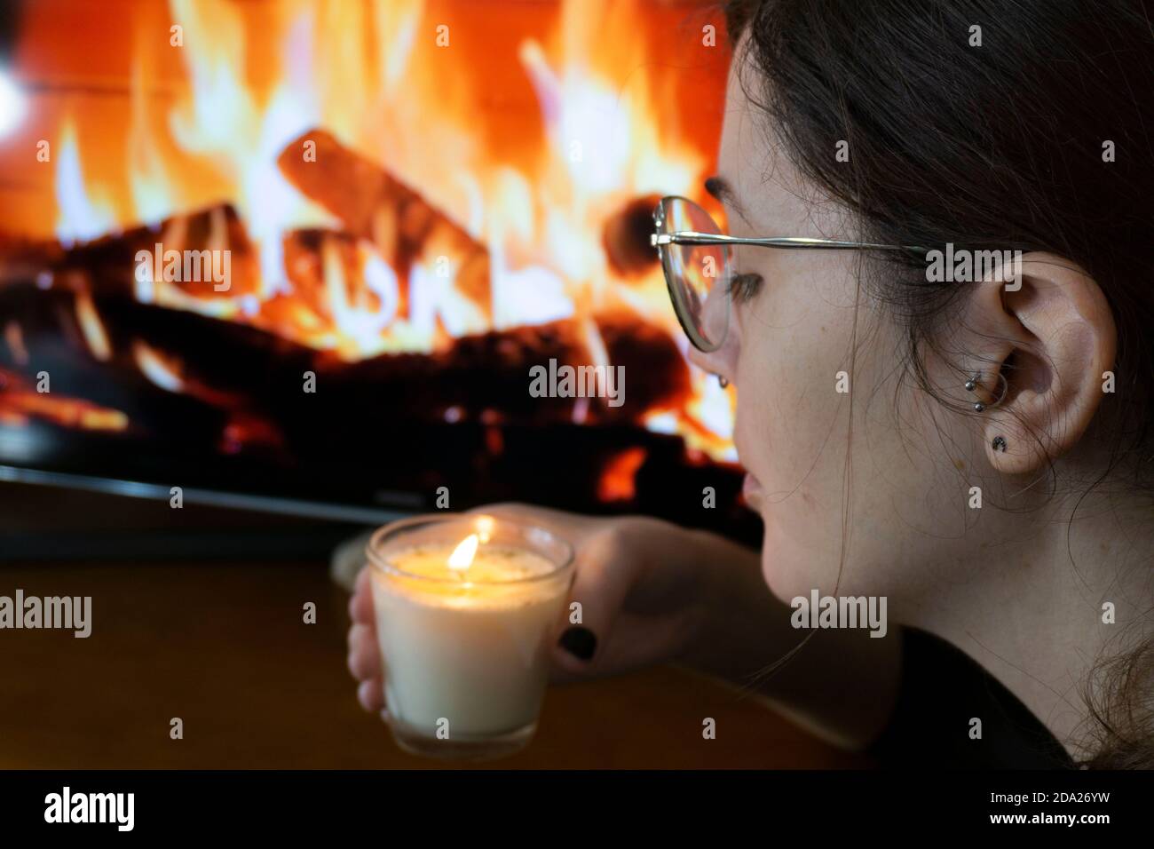 blowing out a candle in front of the fireplace Stock Photo - Alamy