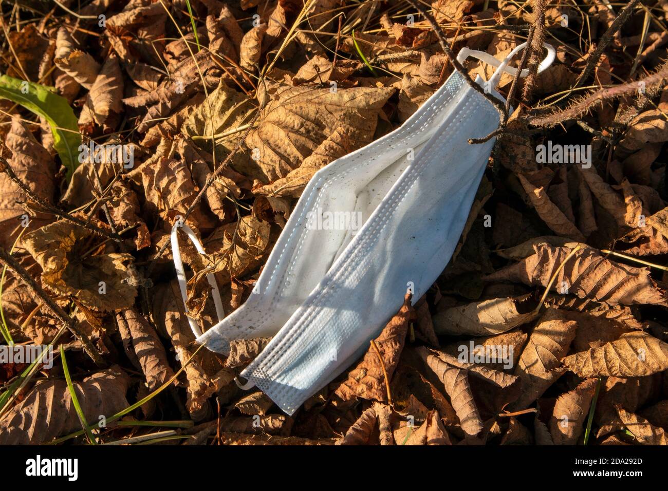 used coronavirus respiratory infection protection mask on ground Stock ...