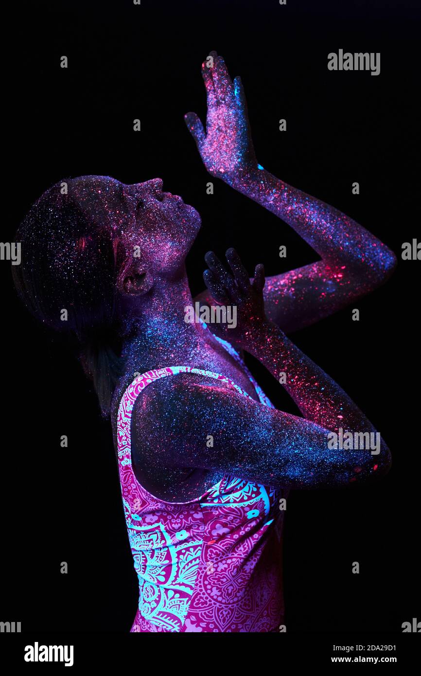 Art woman cosmos in ultraviolet light. Entire body is covered with ...