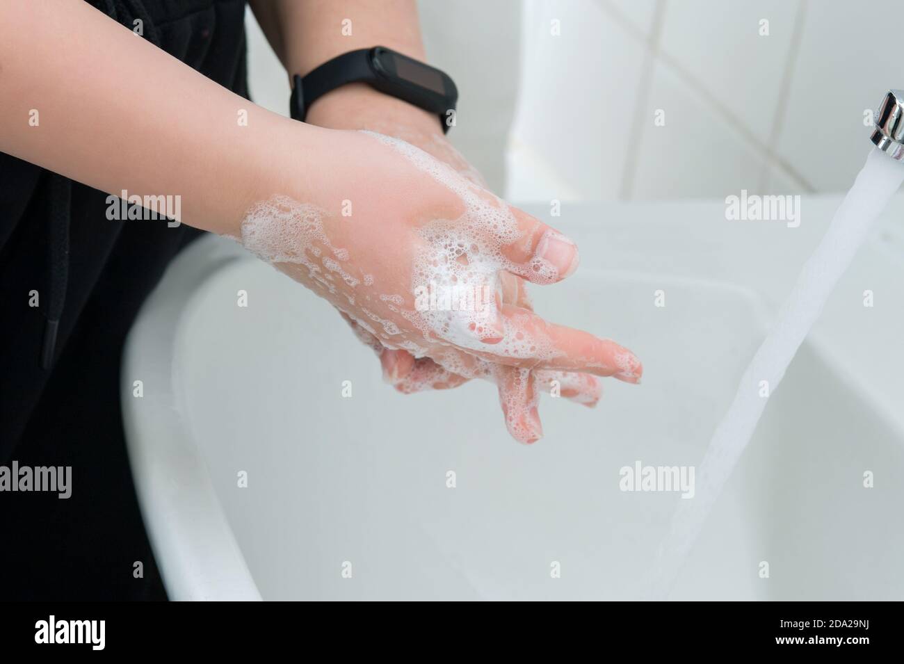 Soapy hands over sink in the bathroom. Hygiene & Cleaning Hands Stock ...