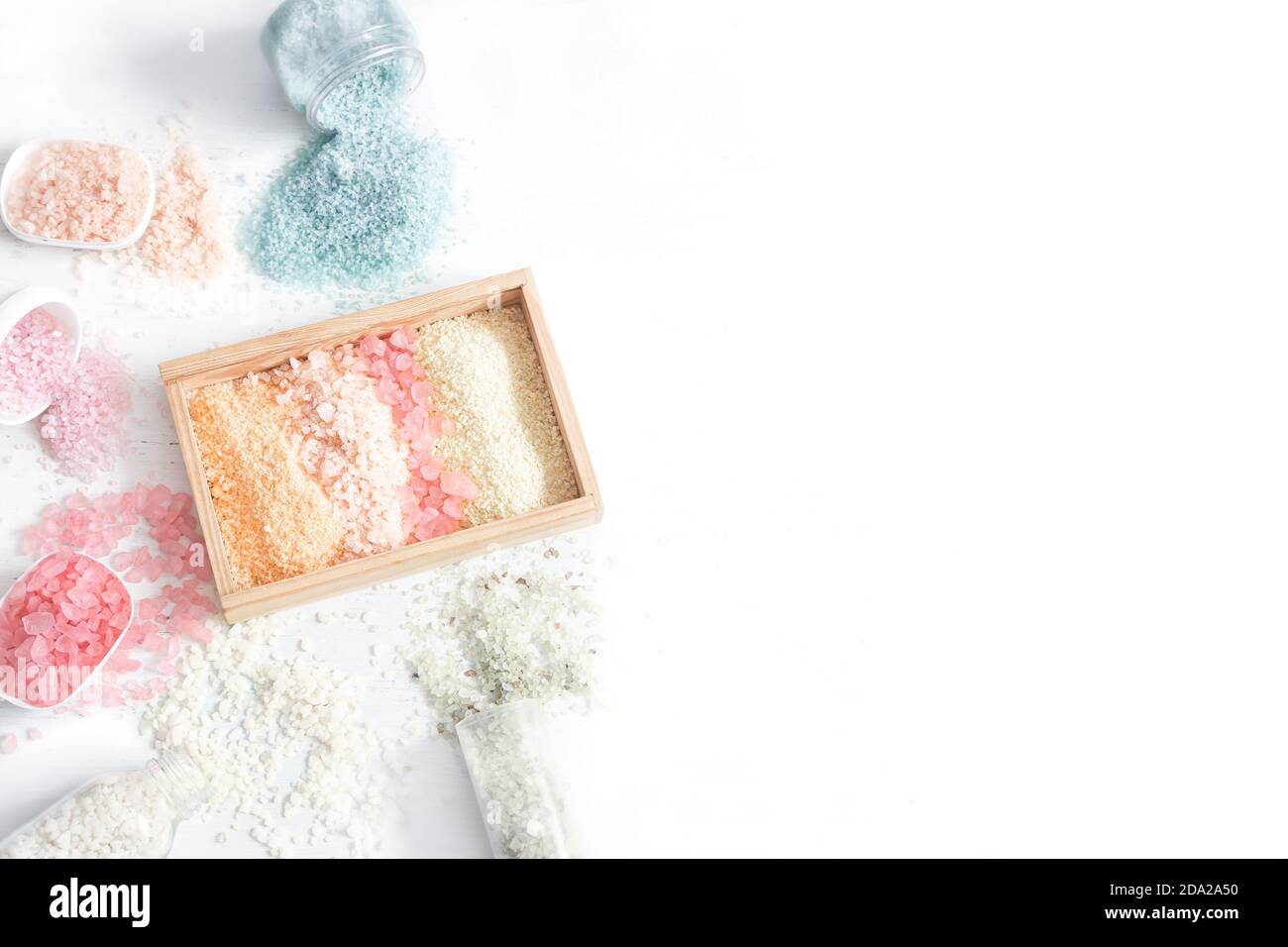 Multicolored sea salt in a box on a white background top view, flat lay ...