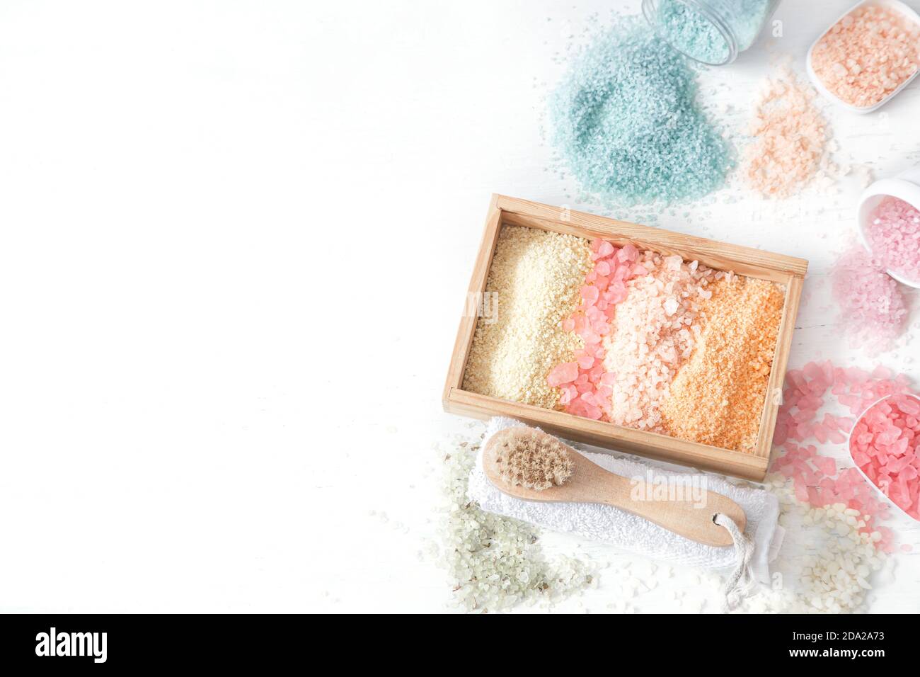 Composition with multi colored sea salt on a white background top view ...