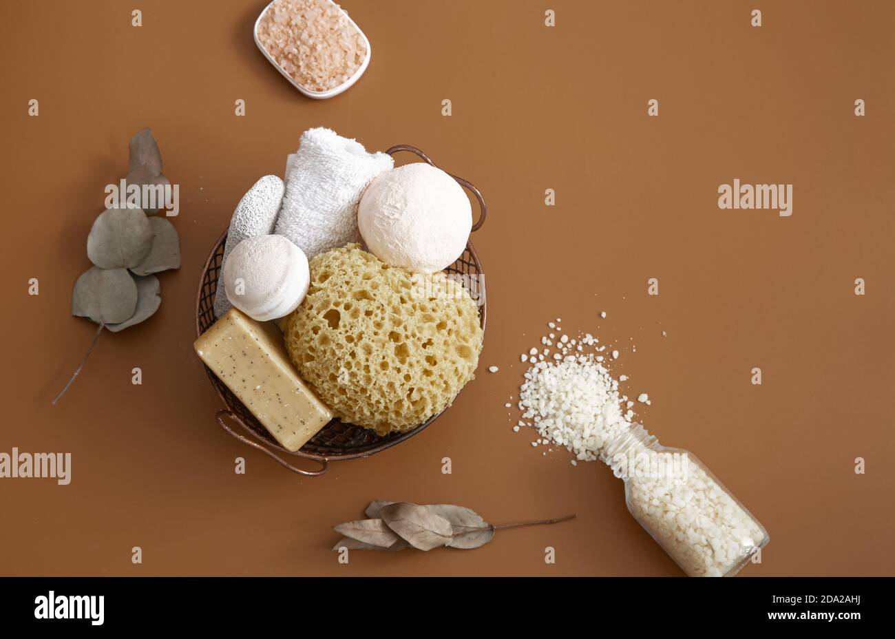 Still life with a bath sponge, bath bombs, soap and sea salt top view ...