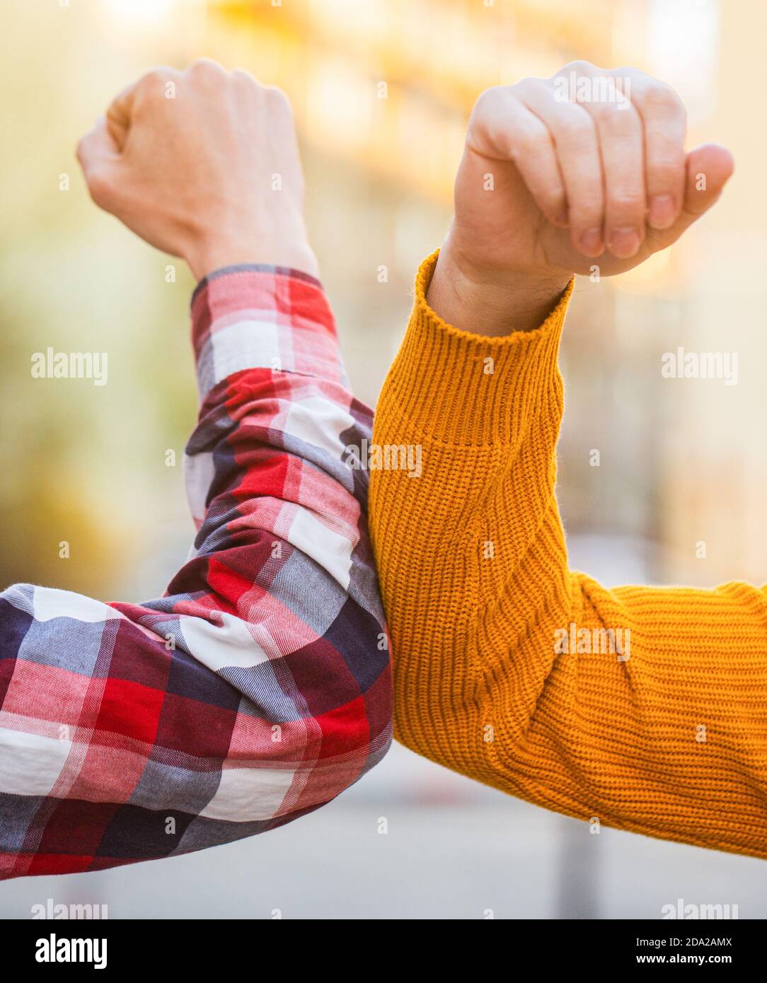 Two people bump elbows to avoid coronavirus outdoors. Coronavirus ...