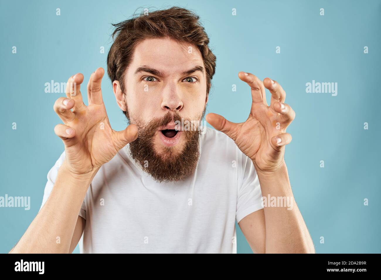 Man with disgruntled facial expression gesturing with hands studio ...