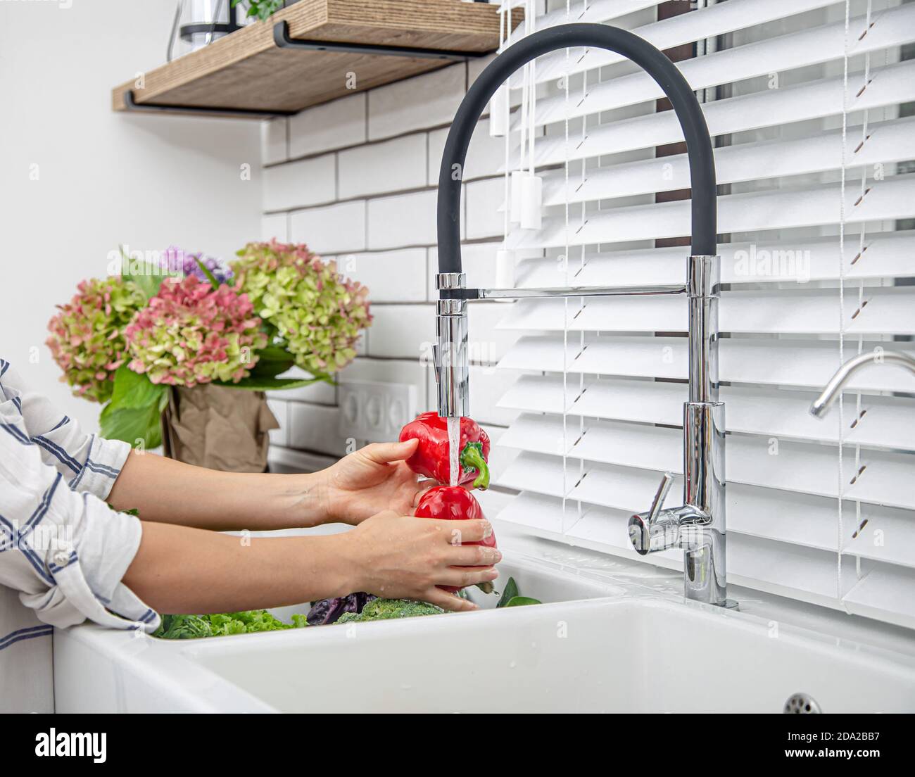 Washing bell pepper with tap water. The concept of natural clean ...