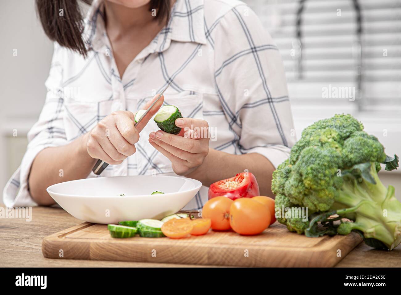The process of preparing a vegetarian salad. Diet and healthy food ...
