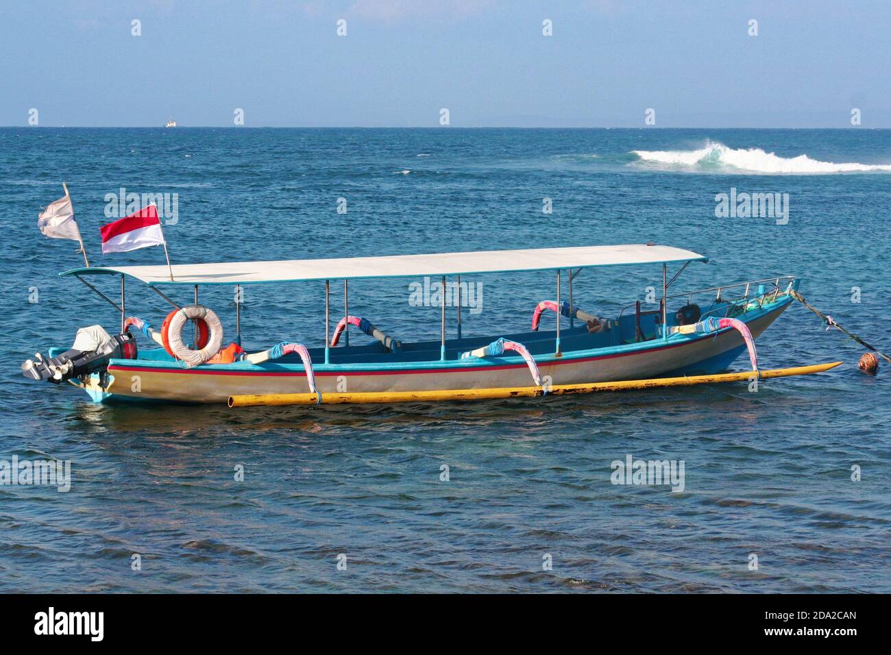 Traditional fishing boat in the sea - Nusa Dua beach - Bali - Indonesia ...