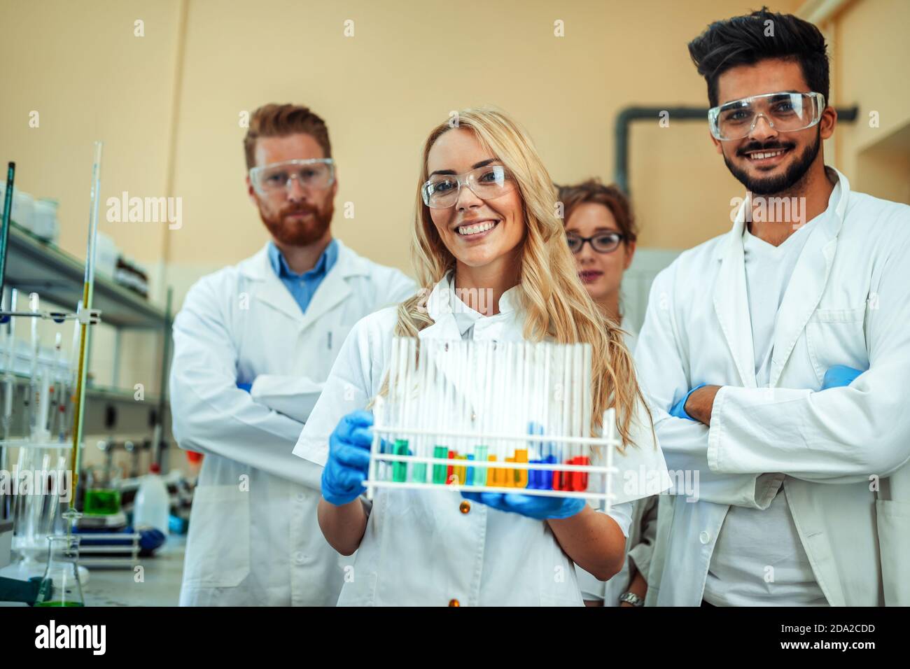 Group of medical research scientists collectively working in laboratory ...