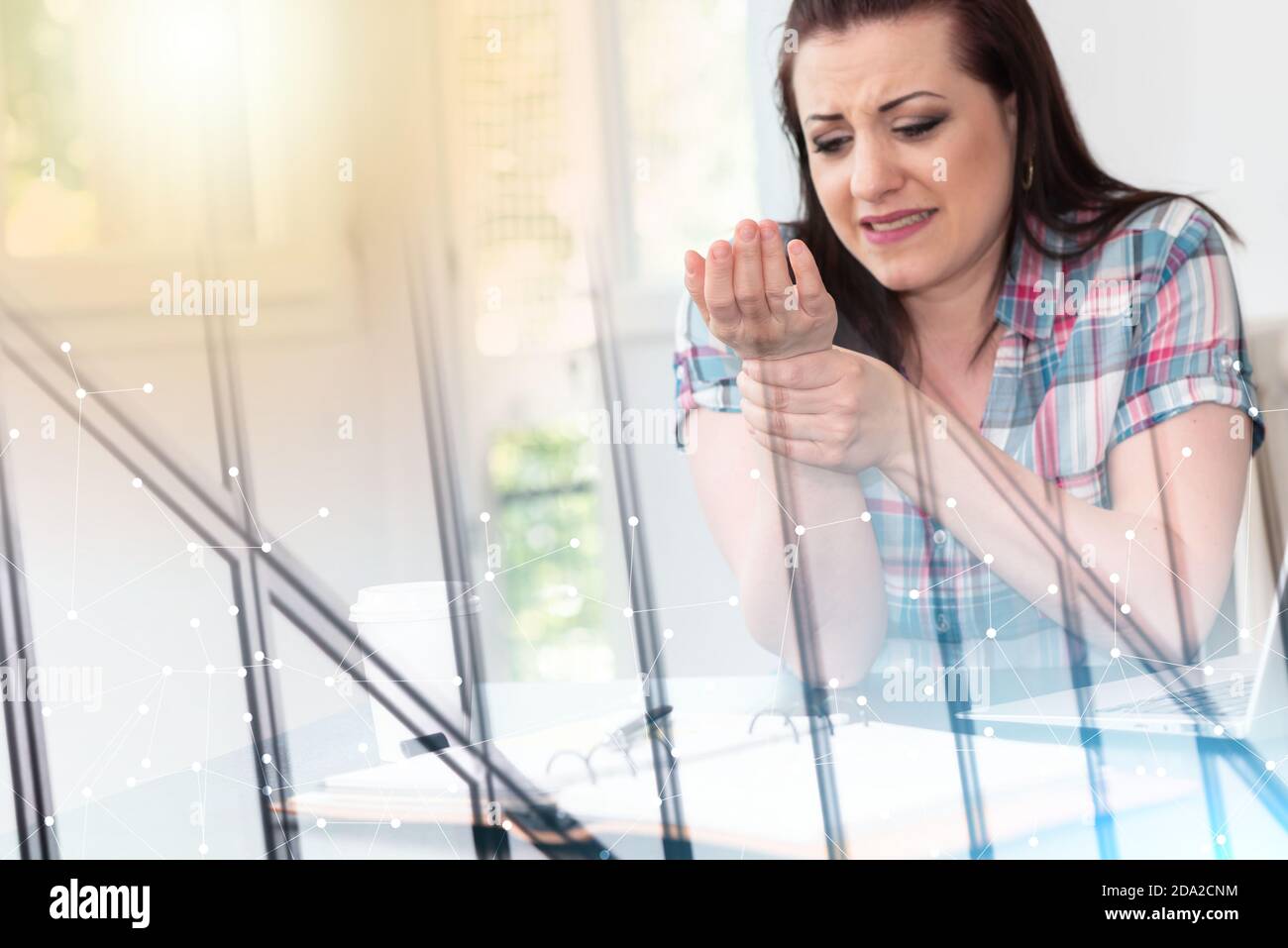 Young businesswoman suffering from wrist pain; multiple exposure Stock ...