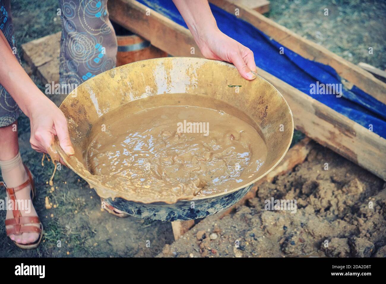 Women's hands with a tray for the extraction of gold sand in US. Woman ...