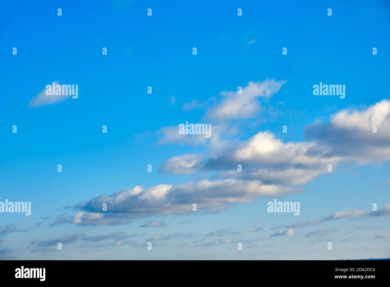 Cumulus cloud on a sunny winter day, copy space. White clouds against a ...