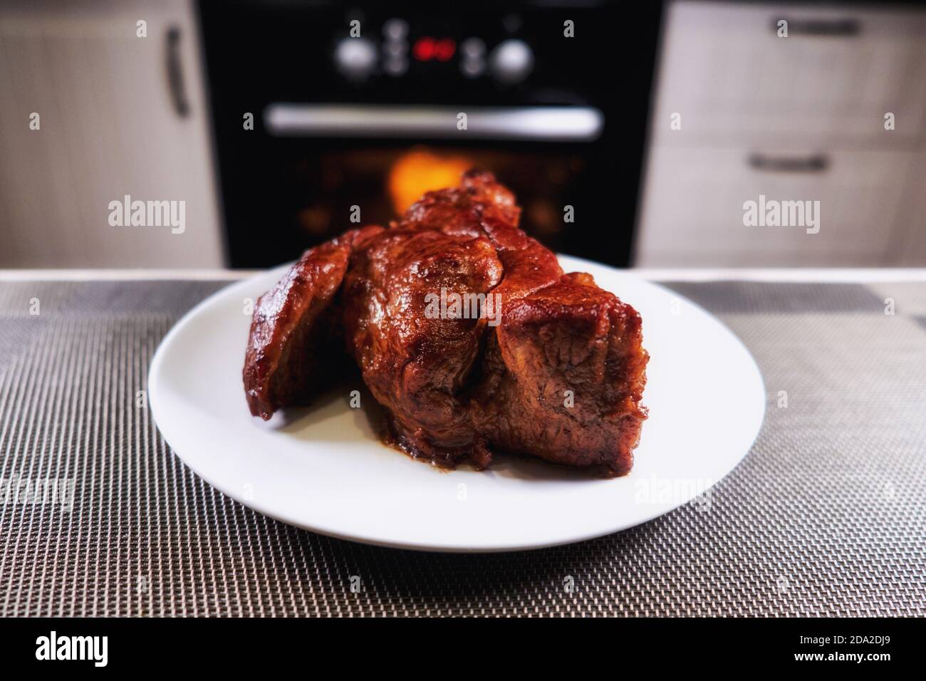 Big piece of meat on plate. Roast beef close-up. Barbecue meat in ...