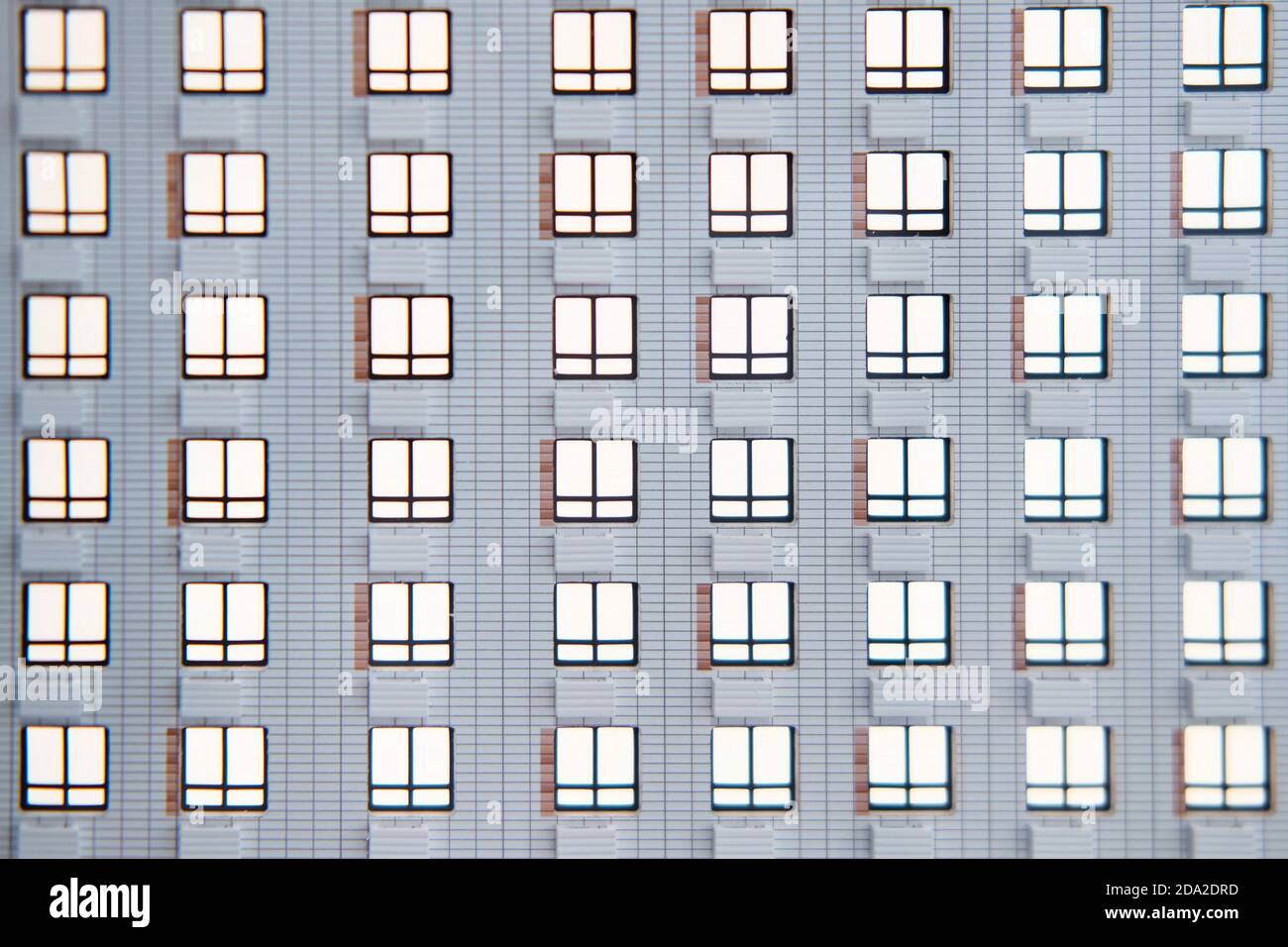 Wall of a white building with luminous windows, background. Closeup of ...