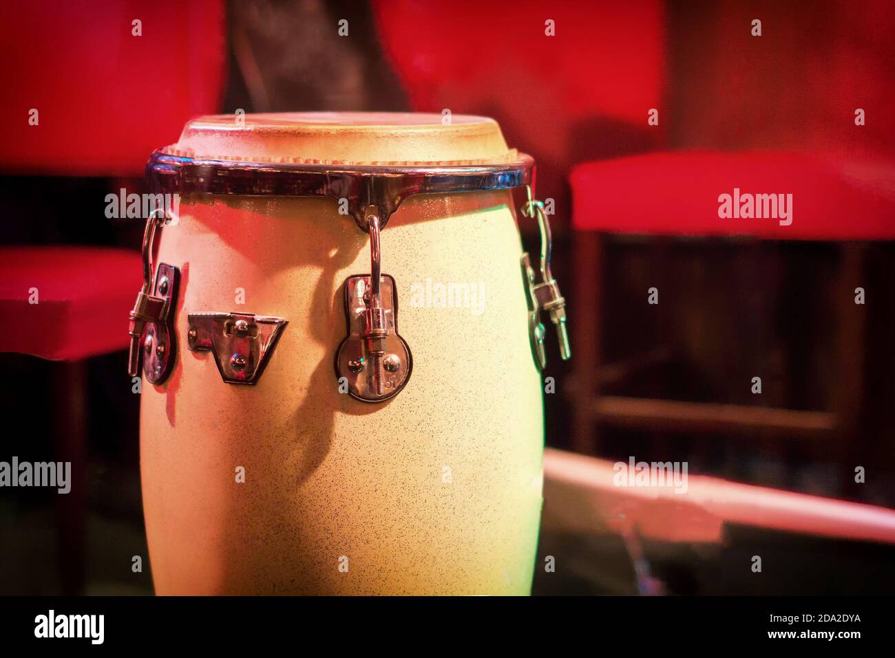 Traditional ethnic Cuban Djembe drum on red background. Percussion ...