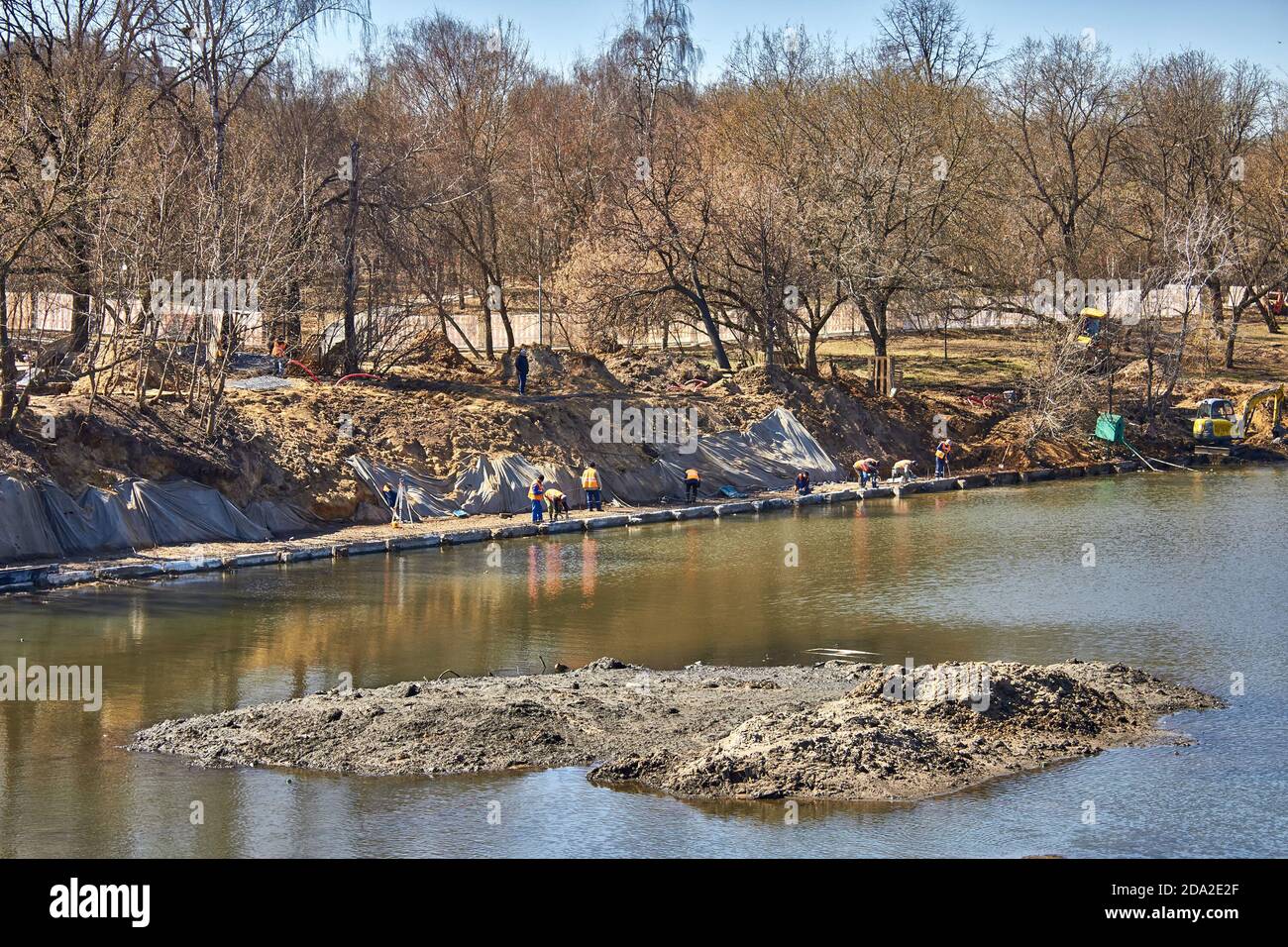 Cleaning of the river by workers and reconstruction of the park area ...