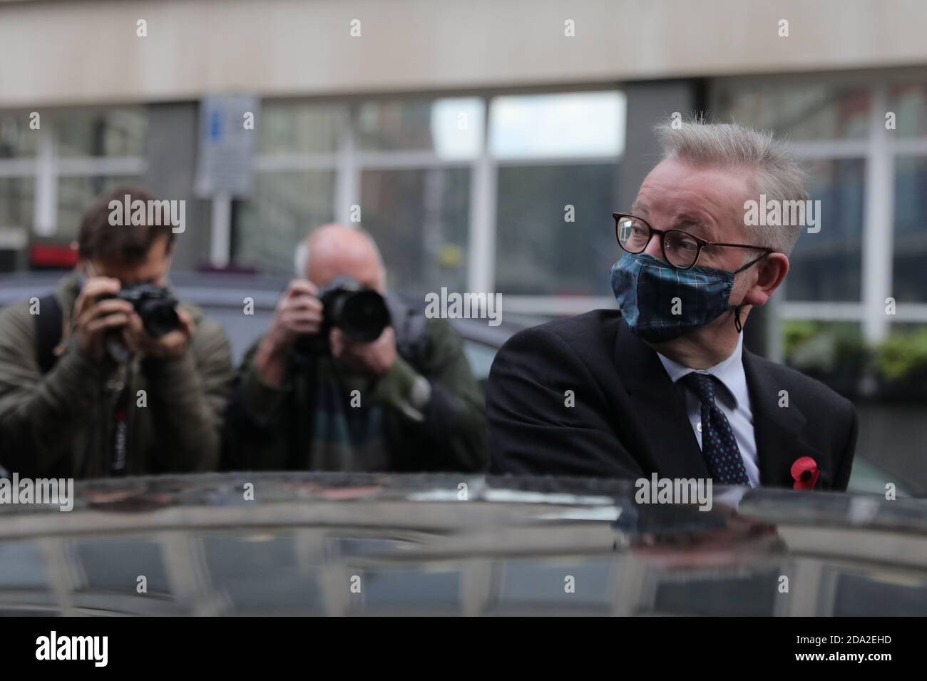 Chancellor of the Duchy of Lancaster Michael Gove wears a face mask as ...