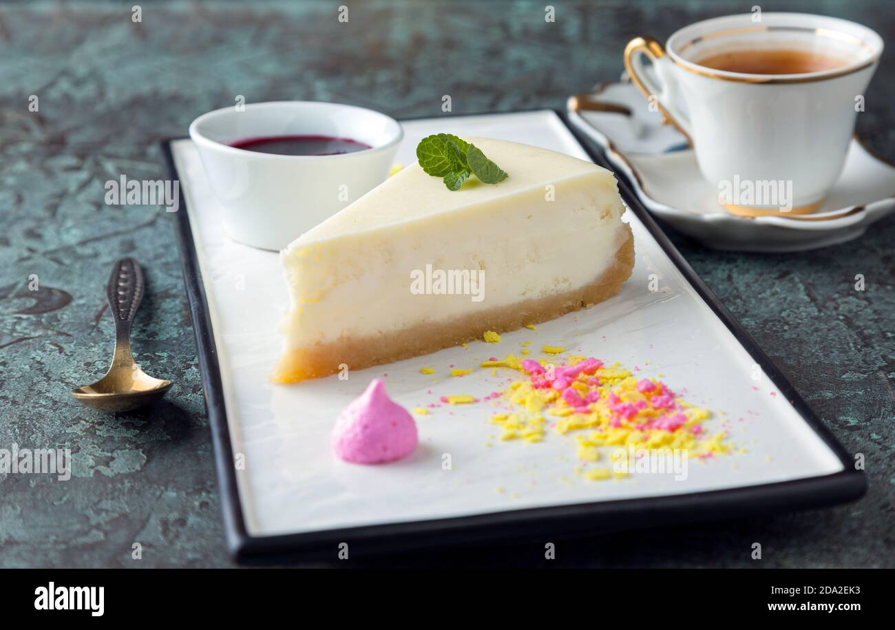 Piece of cheesecake on a rectangular flat plate Stock Photo - Alamy