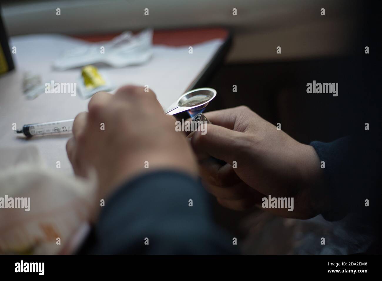 Drug addict prepares and inject his heroin and drugs, inside the Safe ...
