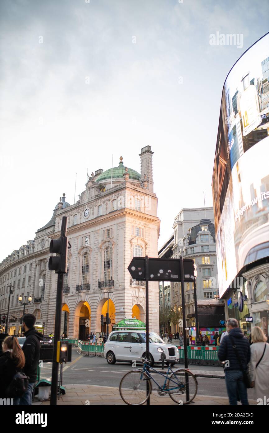 Building with classic architecture in front of a building with large ...