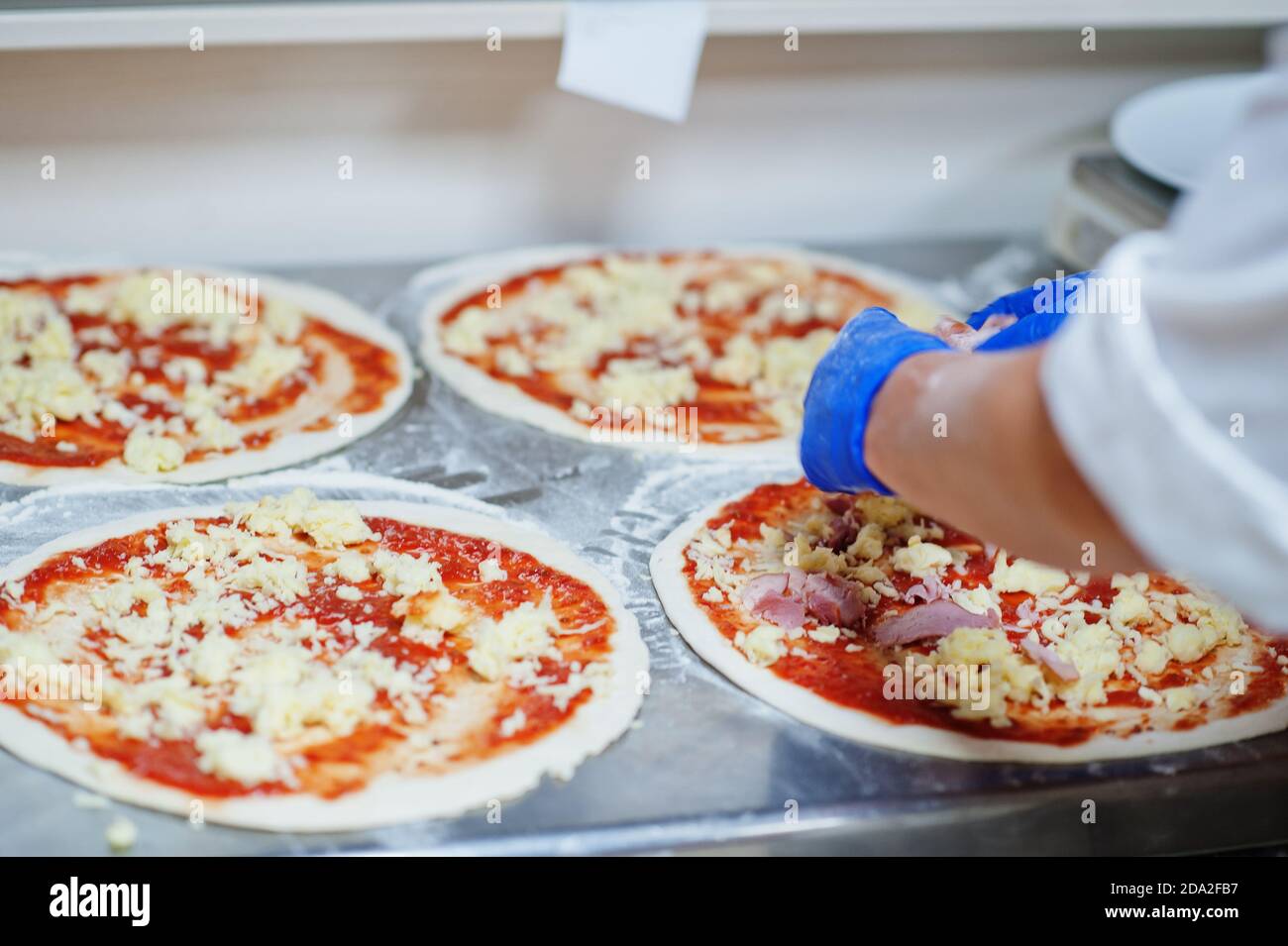 Female chef preparing pizza in restaurant kitchen Stock Photo - Alamy