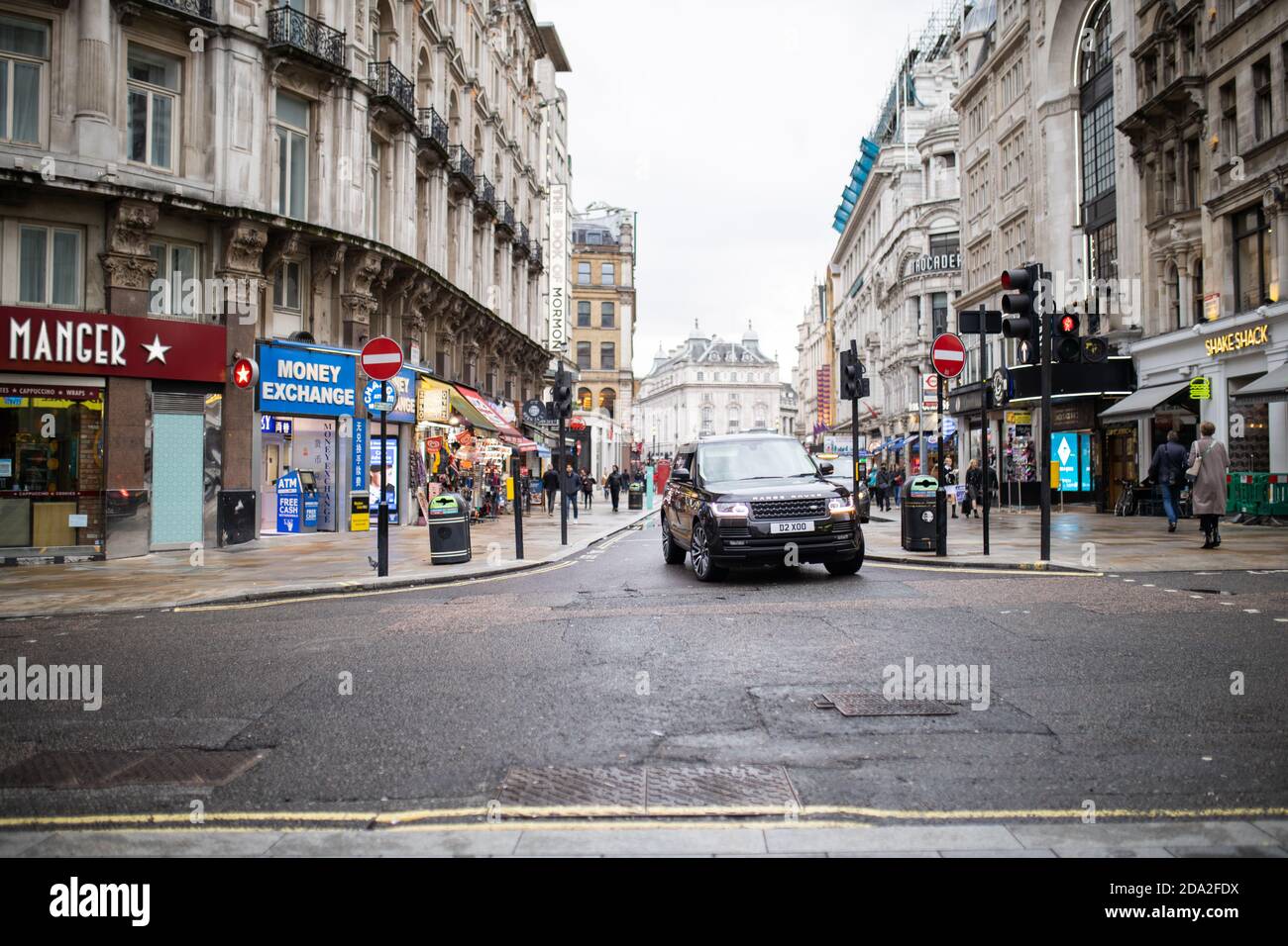 Black car coming from a narrow one-way street turning left at the ...