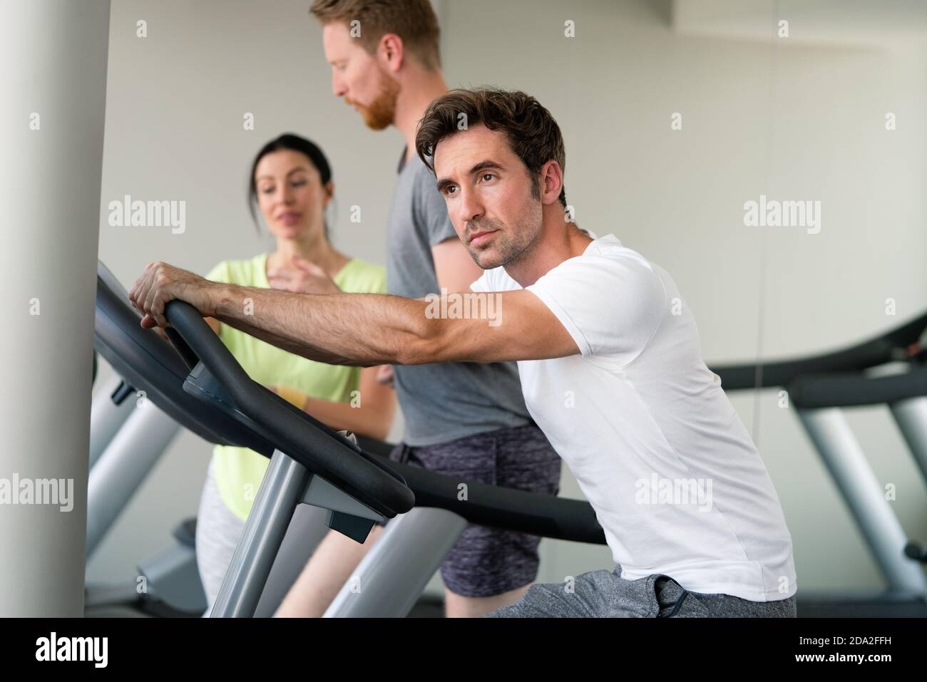 Group of people at the gym exercising on the cardio machines Stock ...