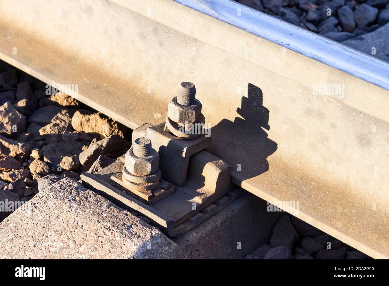 Close-up of iron bolts securing rails to concrete sleepers Stock Photo ...
