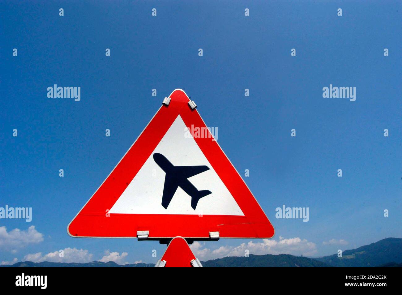 attention air traffic sign, red triangle and airplane pictogram, blue ...
