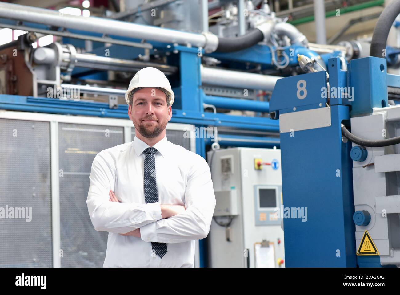 portrait of a successful smiling businessman/ engineer on site in an ...
