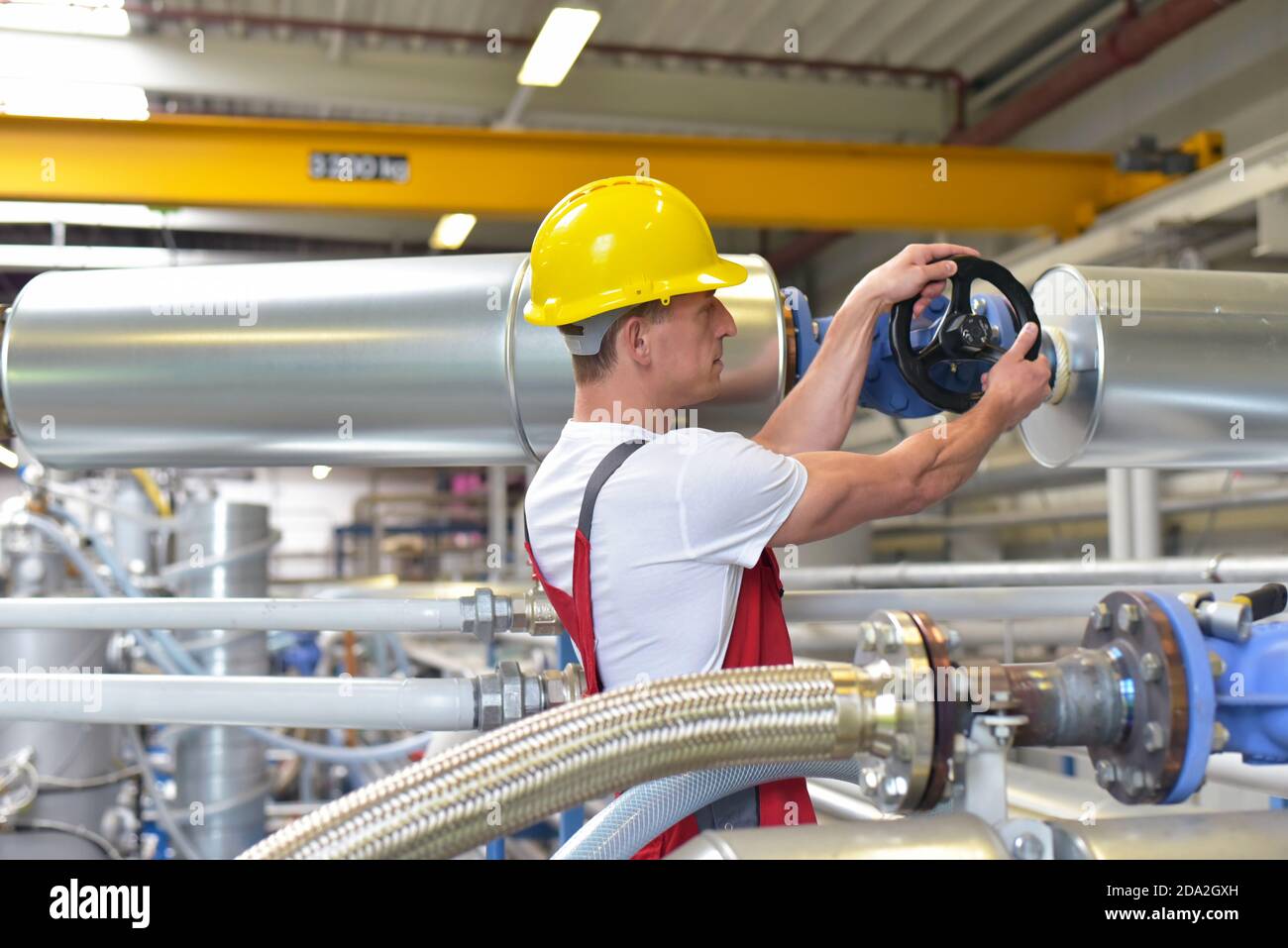 Mechanics repair a machine in a modern industrial plant - profession ...