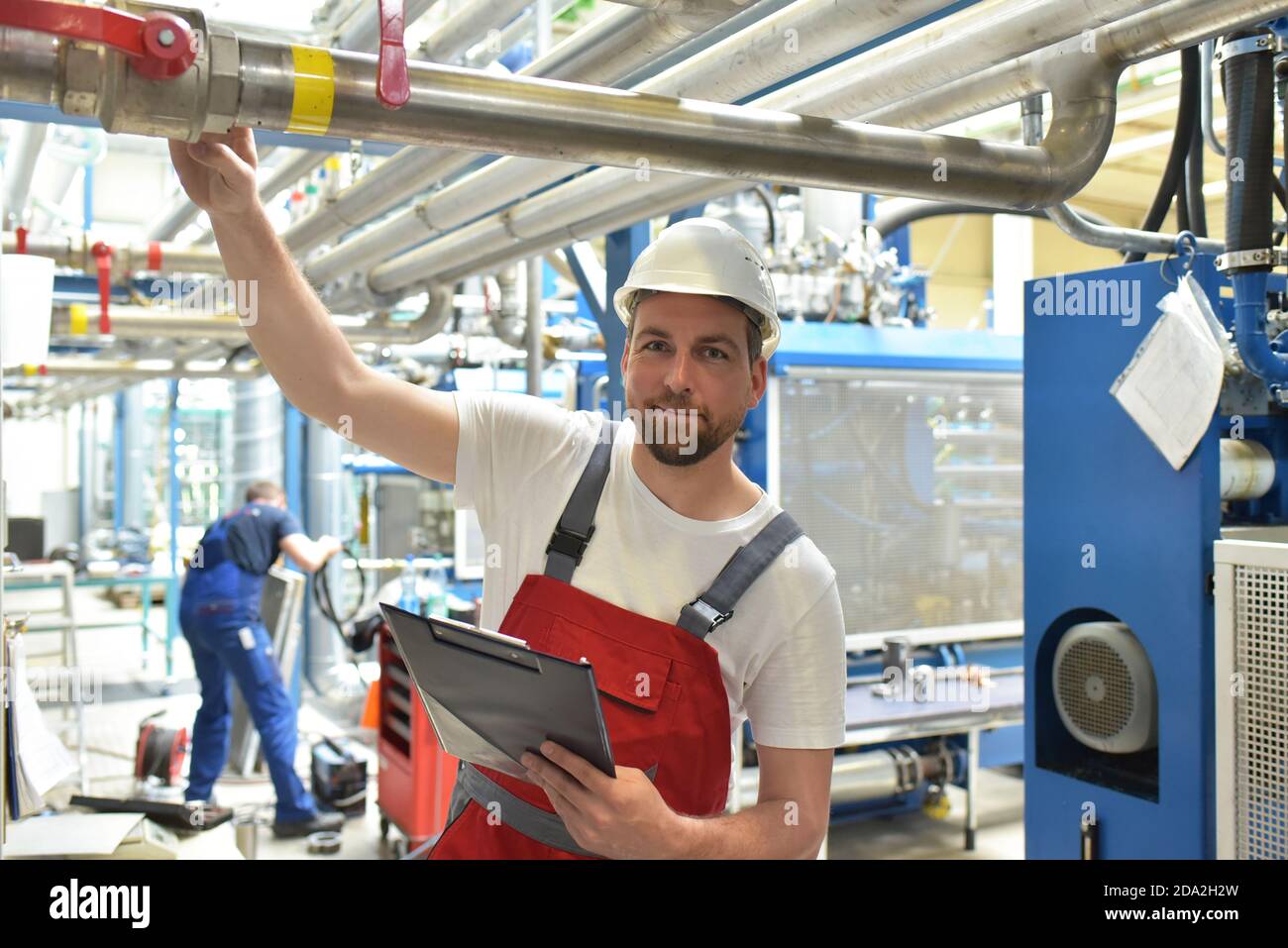 Mechanics repair and inspect an industrial plant in a modern factory ...