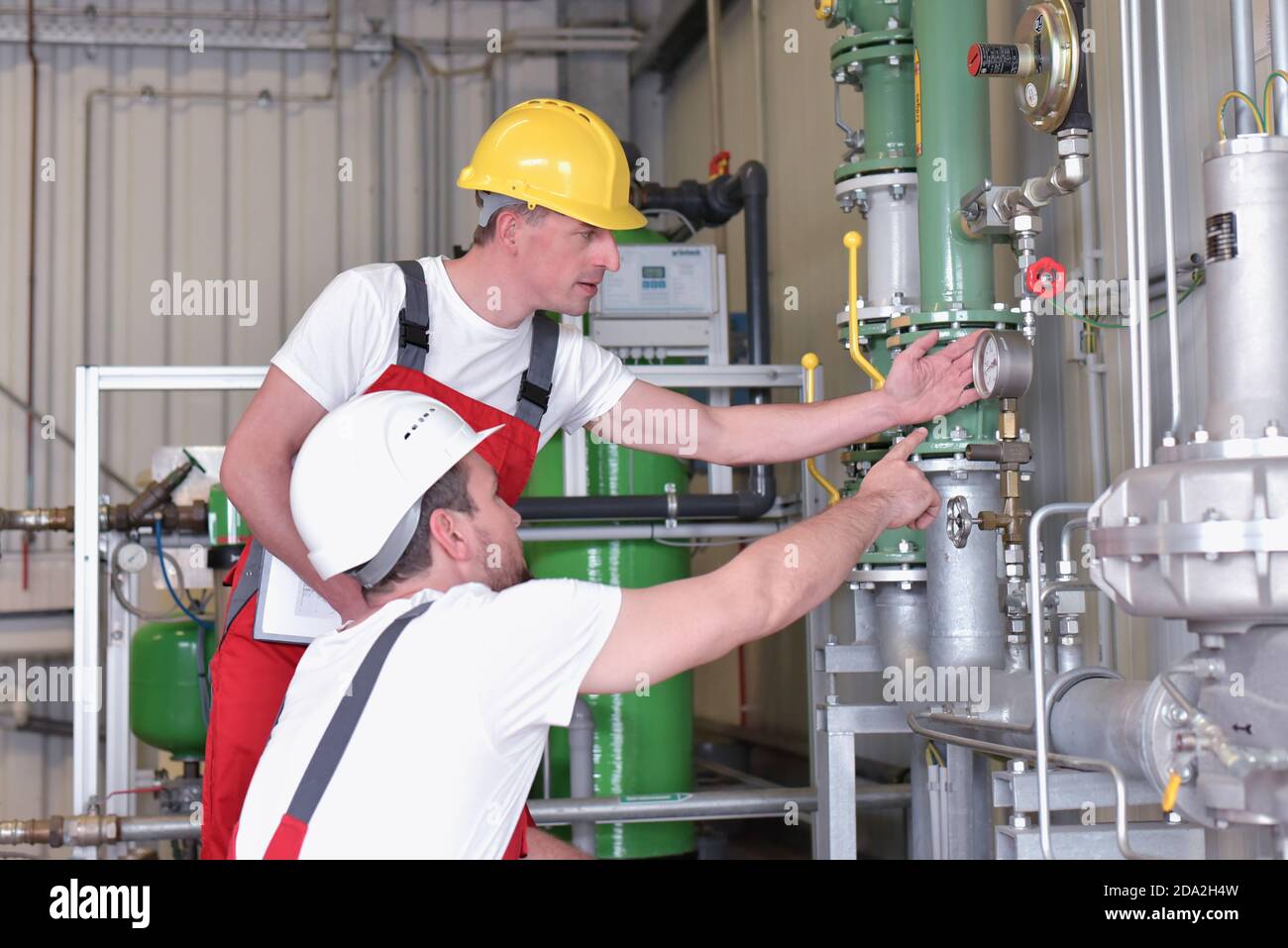 Mechanics repair a machine in a modern industrial plant - profession ...
