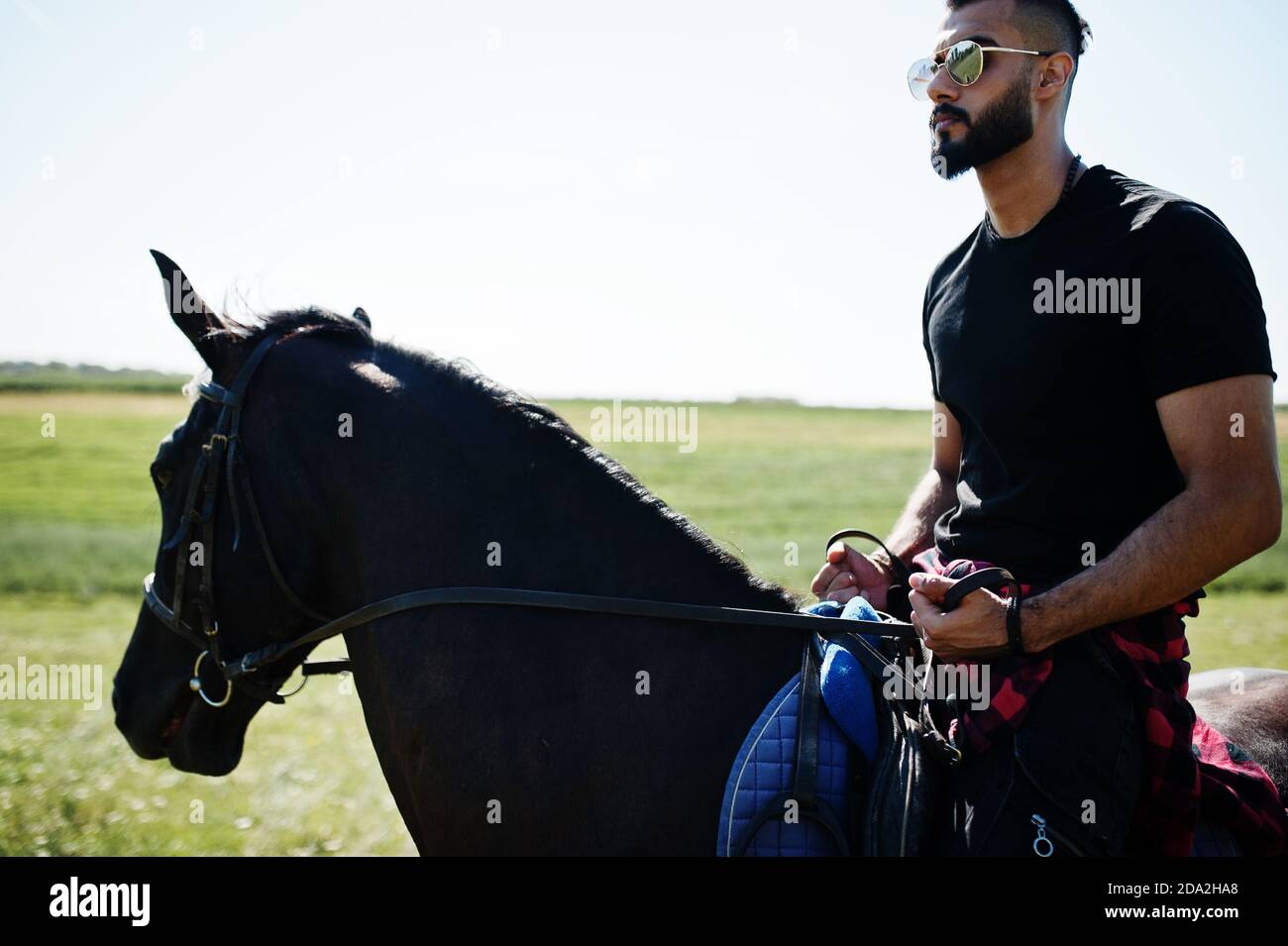 Arab tall beard man wear in black and sunglasses ride arabian horse ...