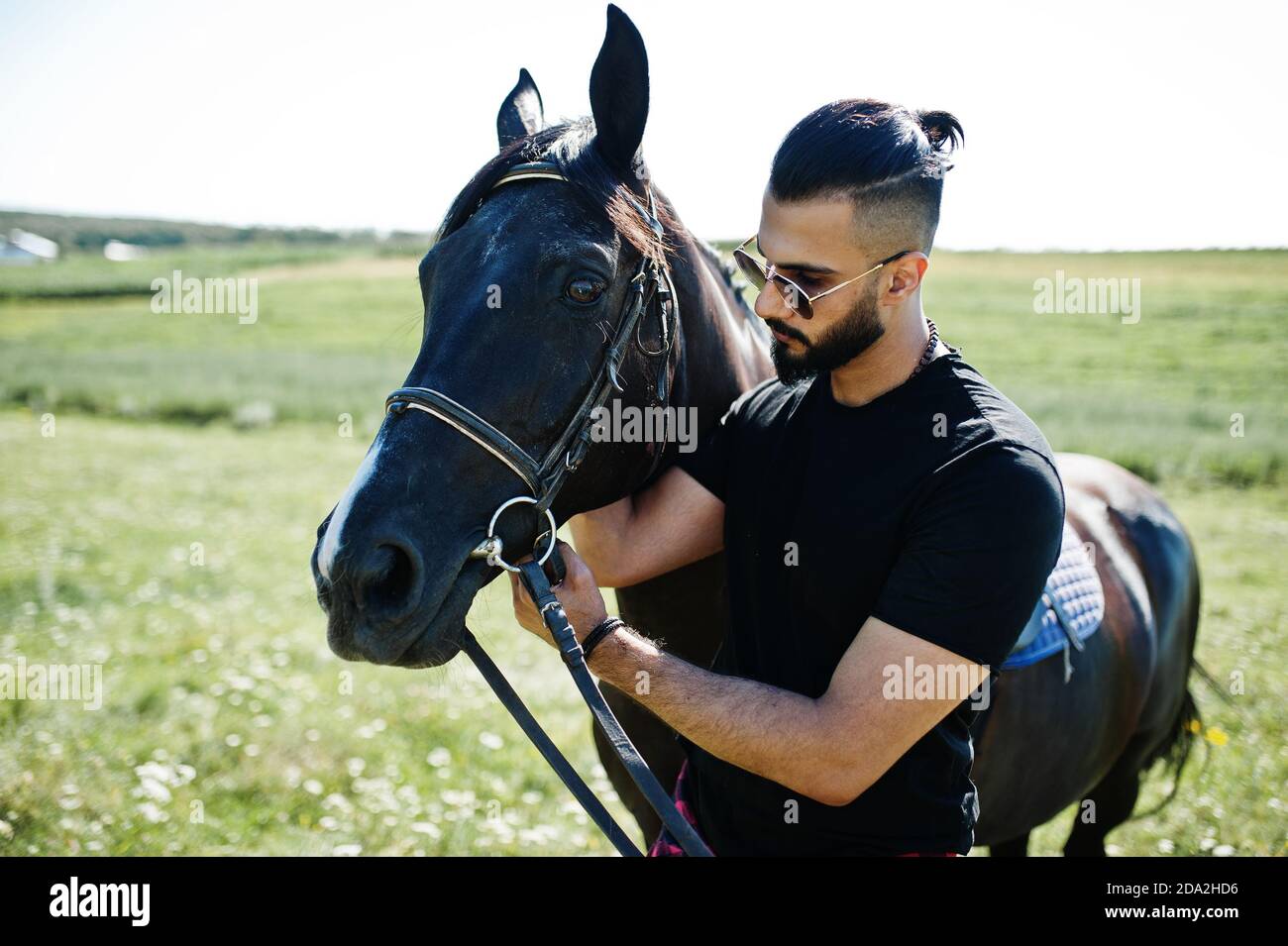 Arab tall beard man wear in black and sunglasses with arabian horse ...