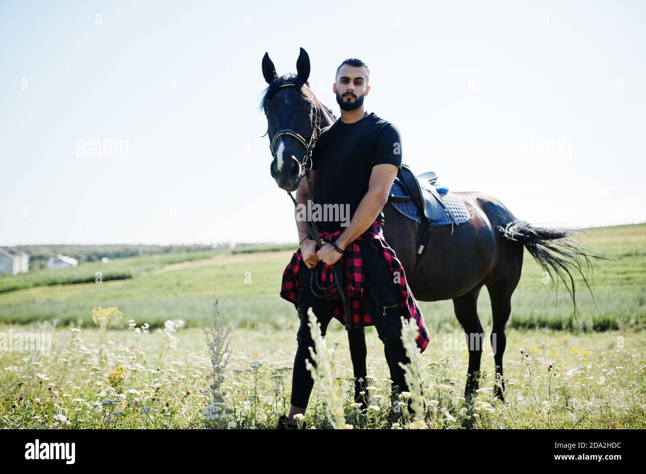Arab tall beard man wear in black with arabian horse Stock Photo - Alamy