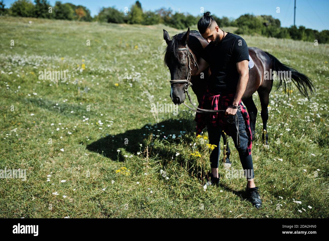 Arab tall beard man wear in black with arabian horse Stock Photo - Alamy
