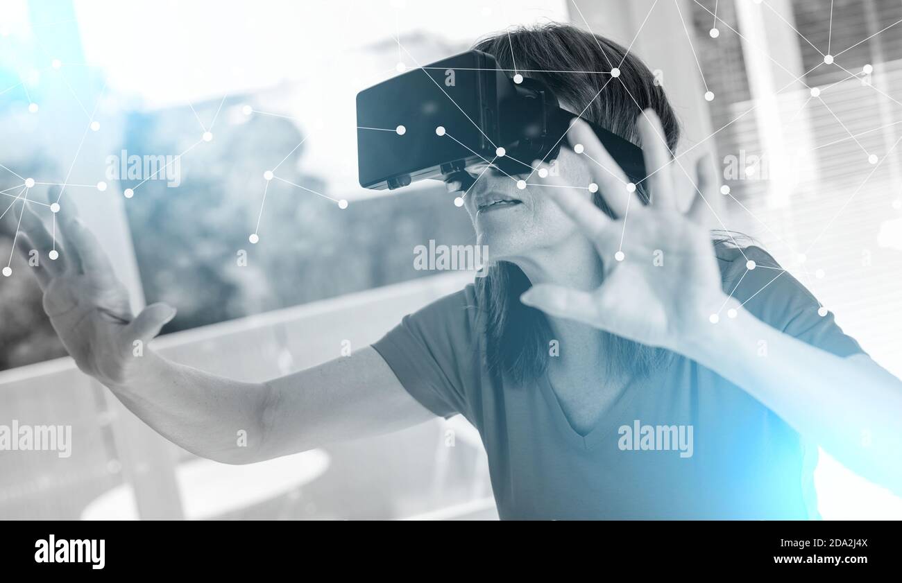 Mature woman using a virtual reality headset; multiple exposure Stock ...